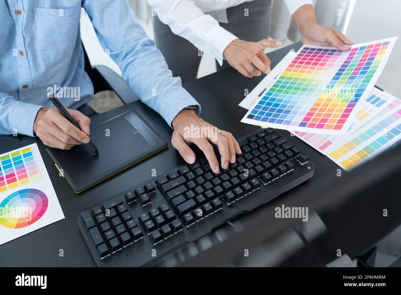 graphic designer team working on web design using color swatches ...