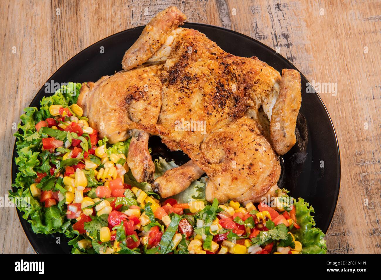 Chicken recipe, roast cockerel and its vegetables, corn condiment Stock ...