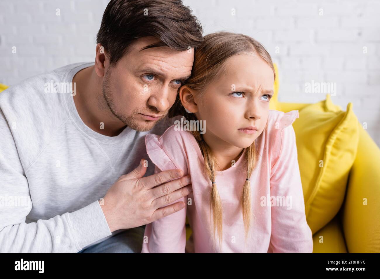 offended girl looking away near sad father touching her shoulder Stock ...