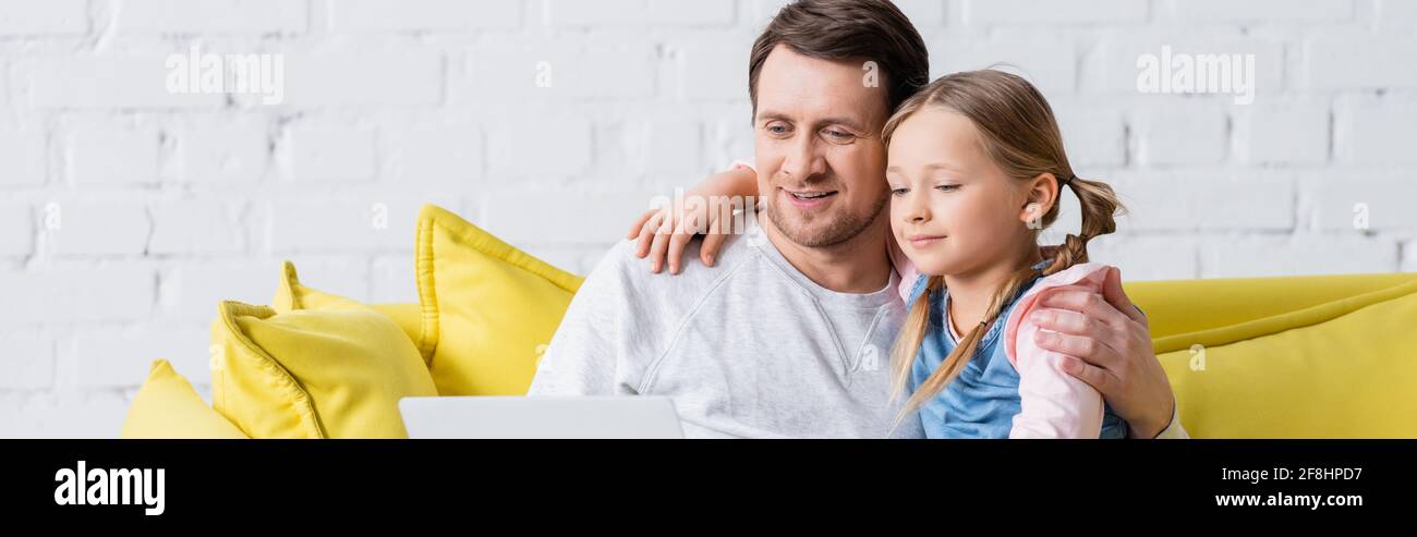 happy dad with daughter watching movie on laptop, banner Stock Photo ...