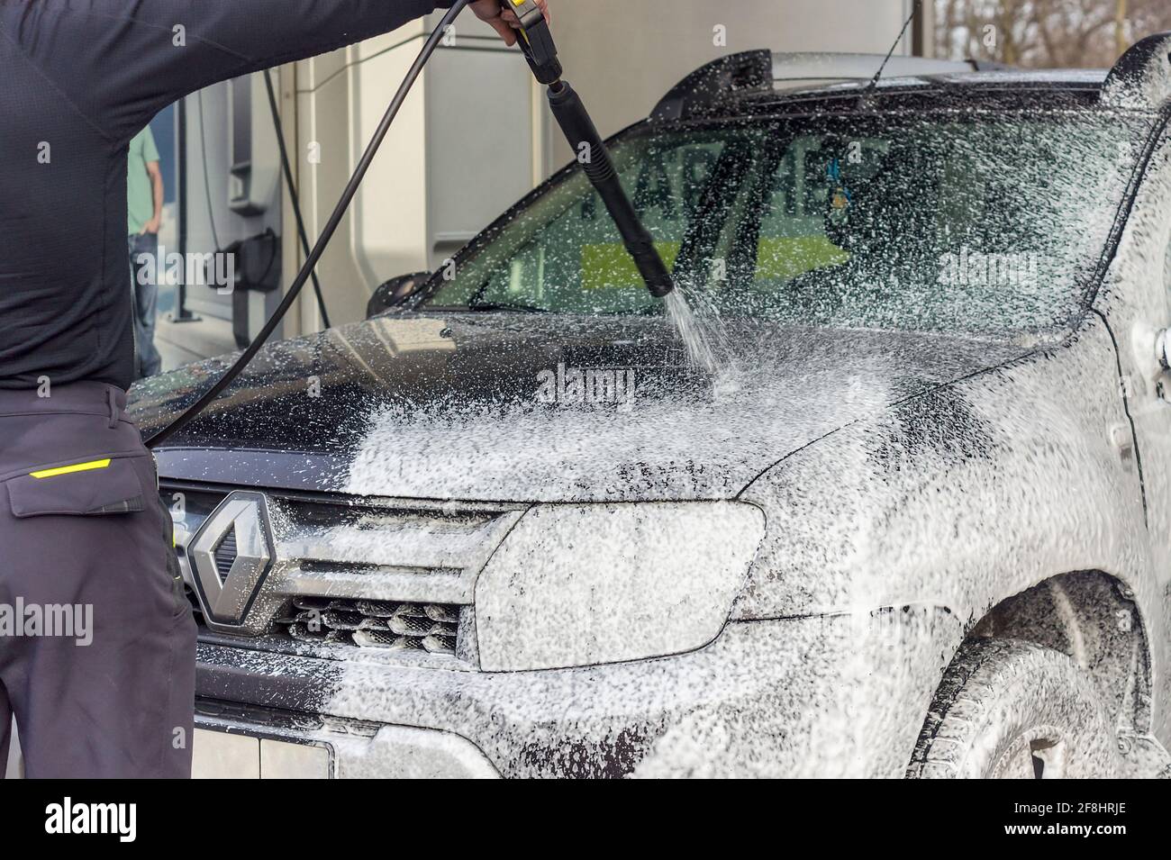 Kaliningrad region, Russia, March 1, 2020. A man washes his car. A man ...