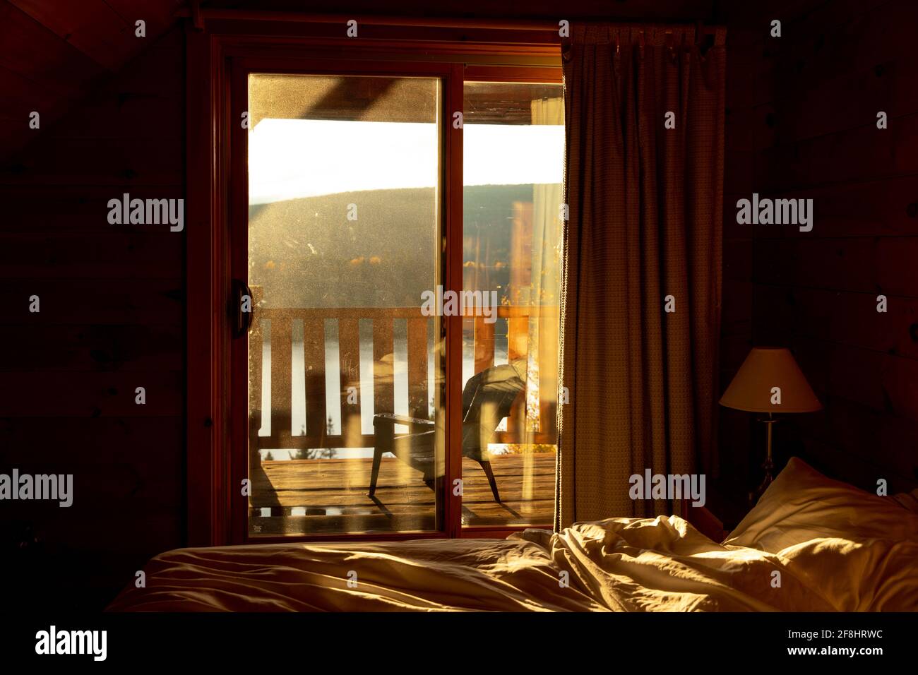 view of a sunset from the inside of a bedroom Stock Photo - Alamy