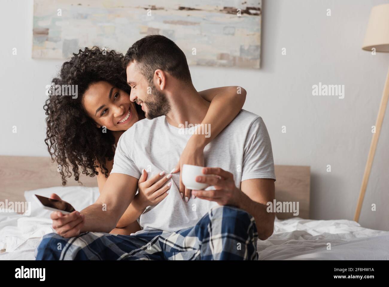 happy african american woman hugging bearded boyfriend holding ...