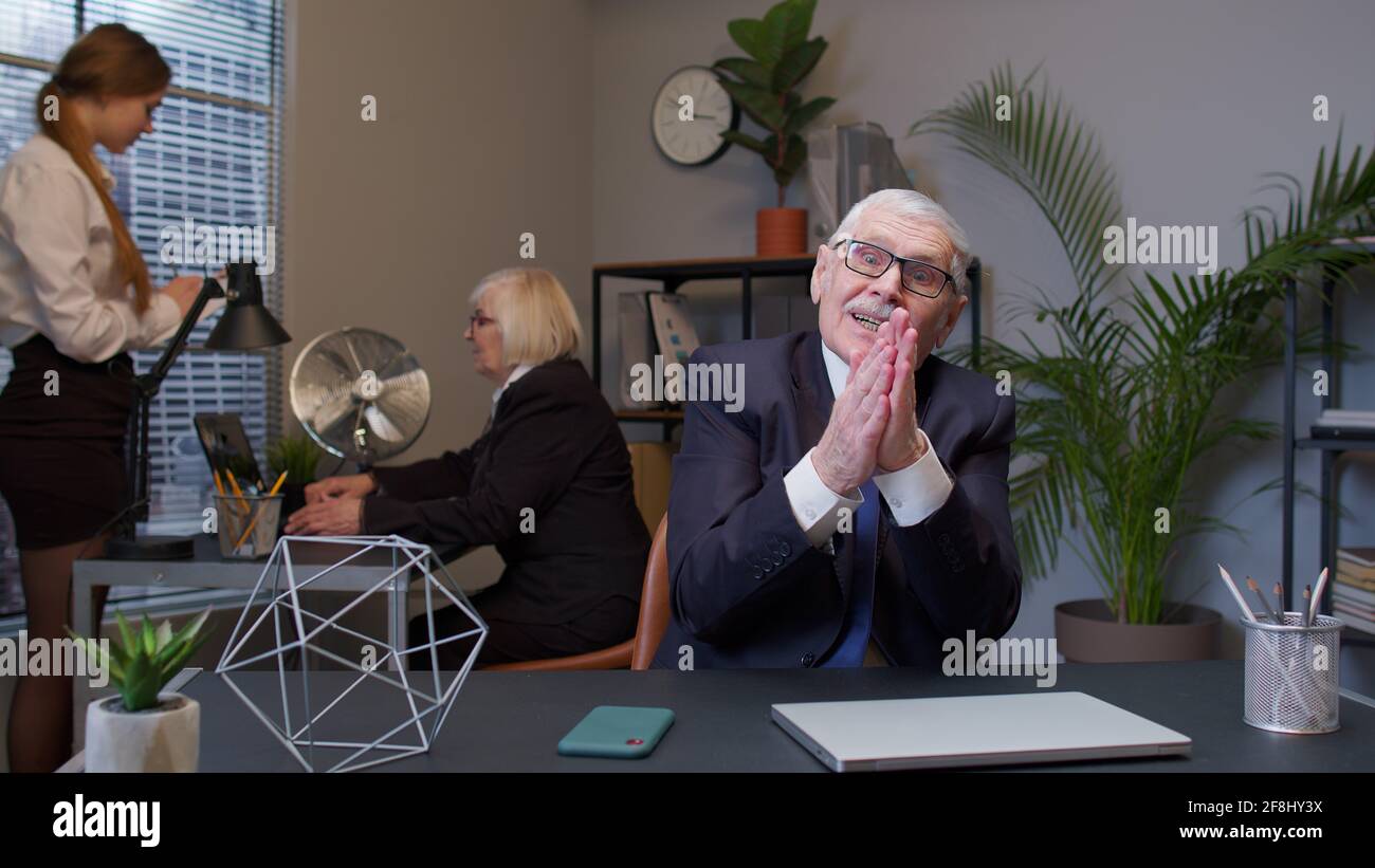 Cunning senior businessman grandfather company director rubbing hands ...