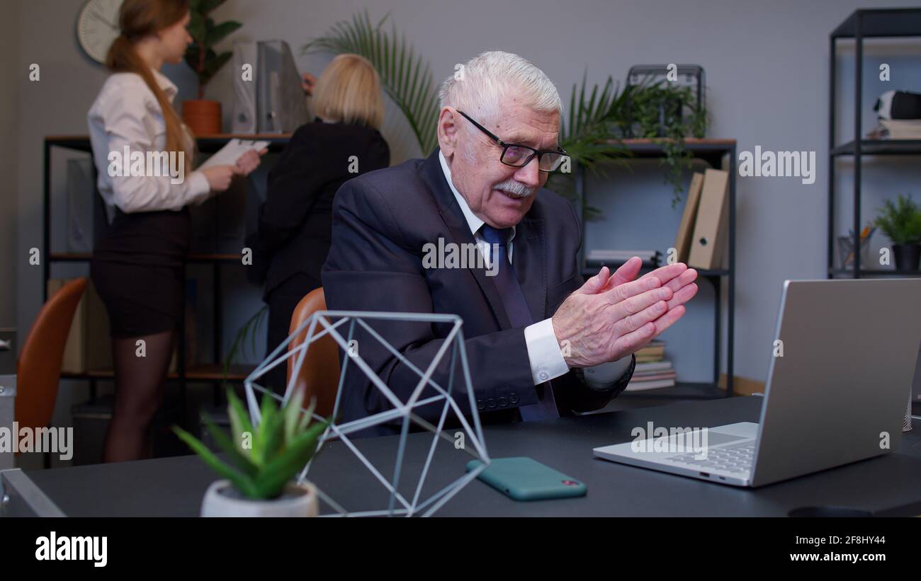 Cunning senior businessman rubbing hands, scheming evil tricky prank ...