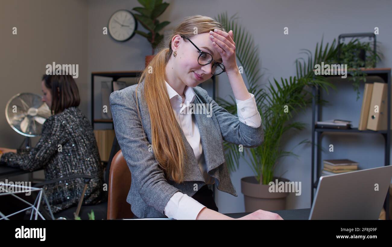 Bored young woman boss doing face palm gesture while developing new ...