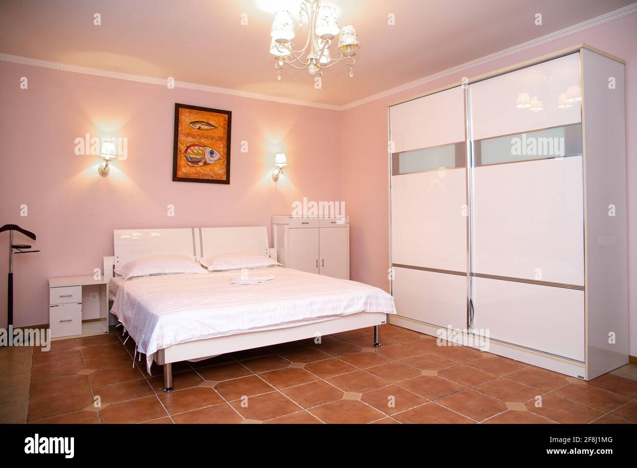 light hotel room with a double bed Stock Photo - Alamy