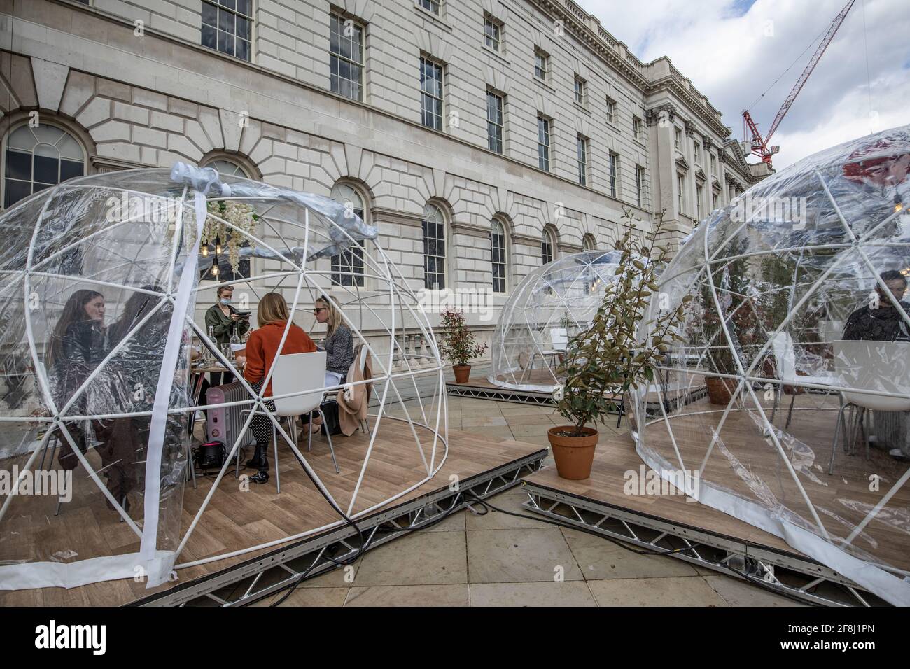 Friends enjoy one of Somerset House’s igloo-style dining domes where ...