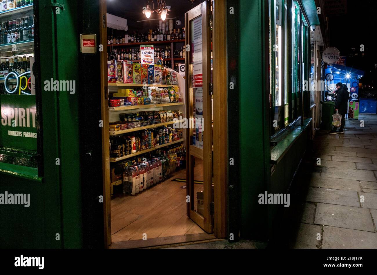traditional corner shop, newsagent and convenience store at night ...