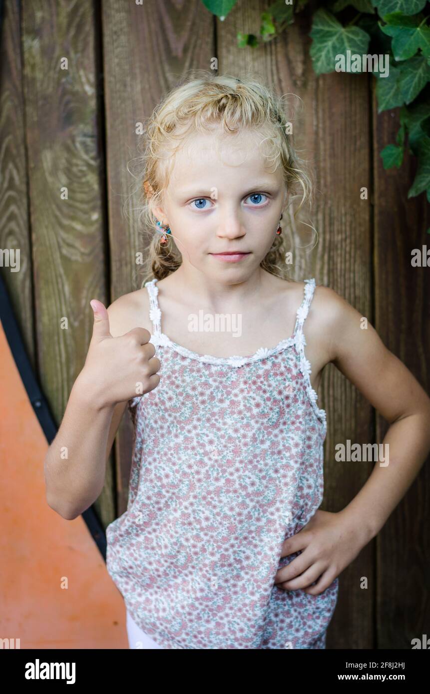 little blond girl showing yes gesture Stock Photo - Alamy