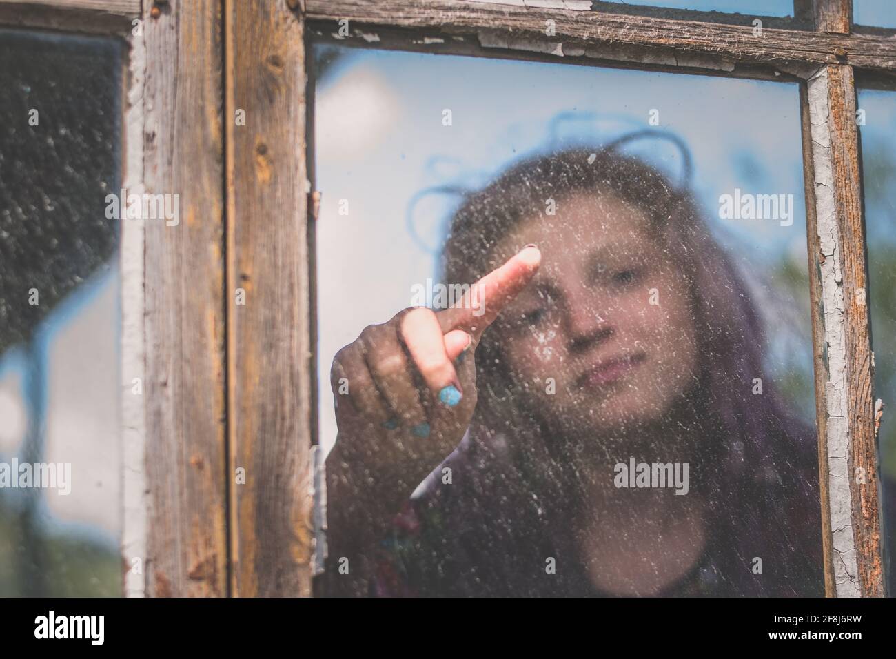 cute girl isolated behind the window Stock Photo - Alamy