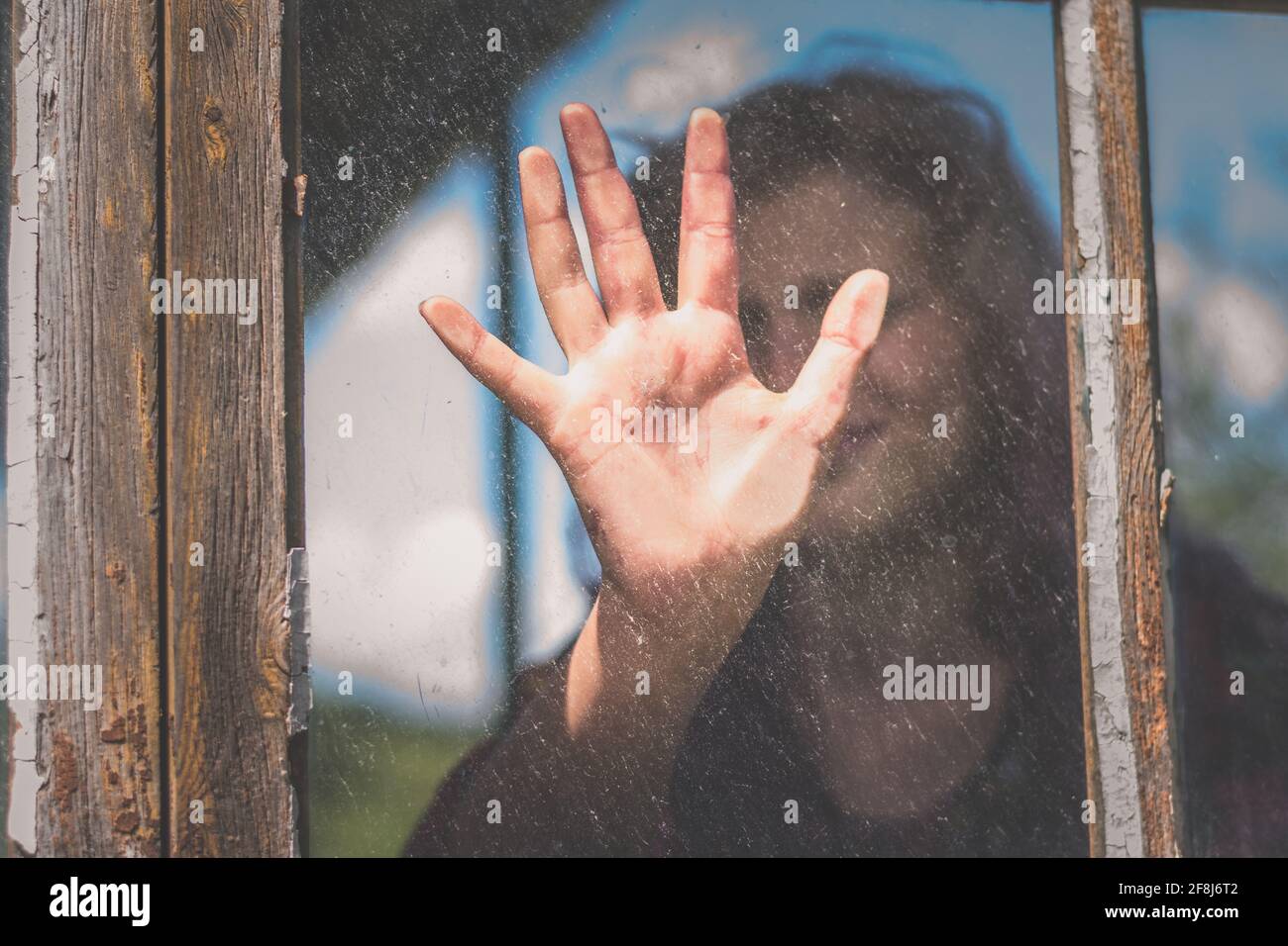 cute girl isolated behind the window Stock Photo - Alamy