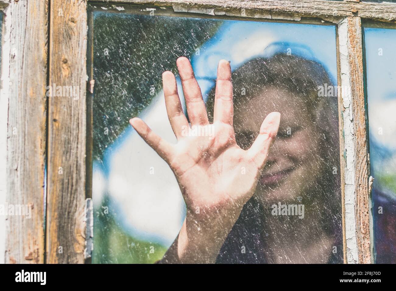 cute girl isolated behind the window Stock Photo - Alamy