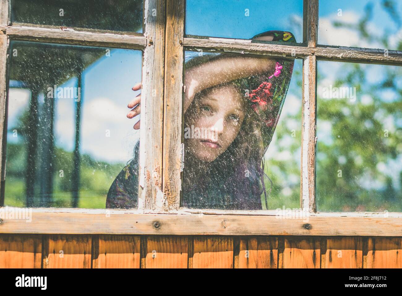 cute girl isolated behind the window Stock Photo - Alamy