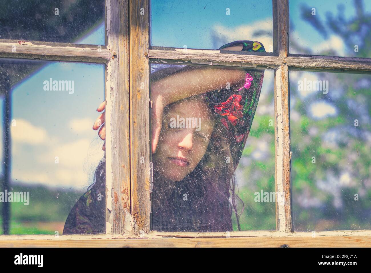 cute girl isolated behind the window Stock Photo - Alamy
