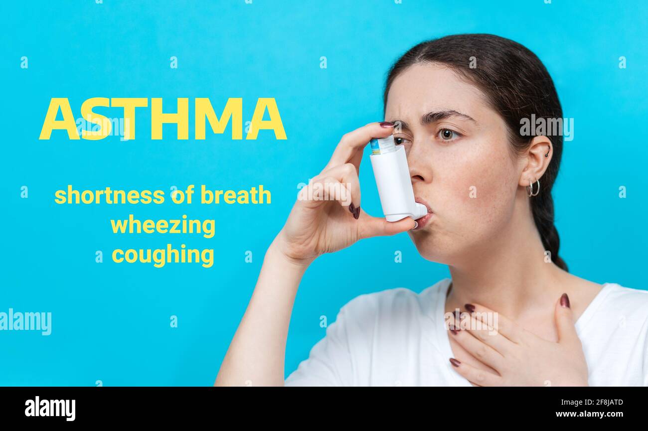 Symptoms of asthma. Portrait of a young woman using an inhaler. Blue ...
