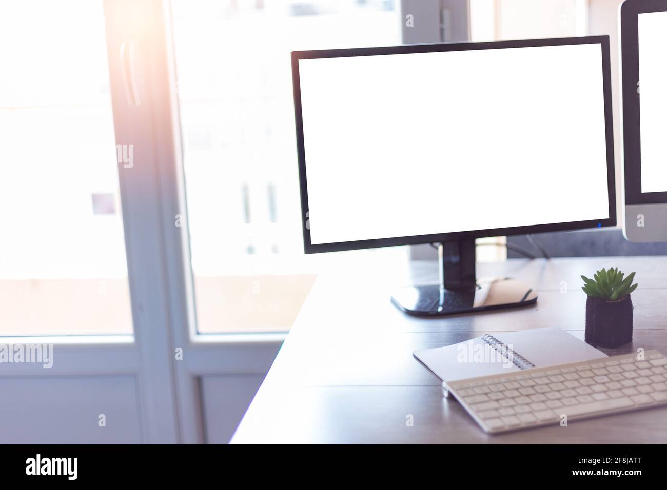 Workplace with a computer, keyboard in front of the window Stock Photo ...