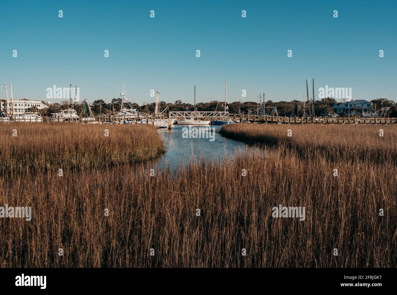 water marsh view with boats and boardwalk with sunny sky Stock Photo ...