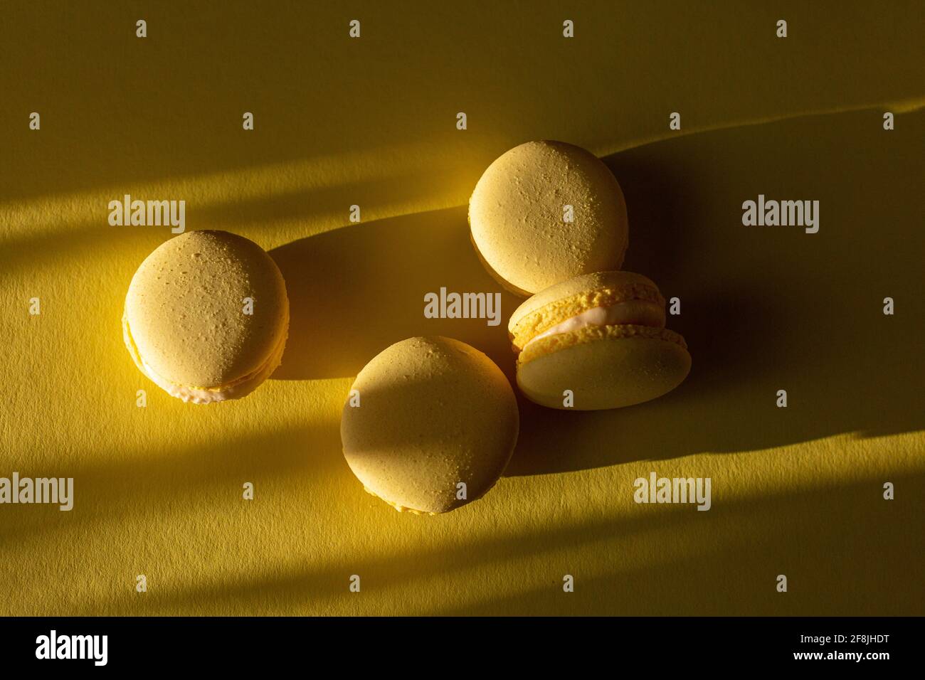 yellow macarons on a yellow background under low morning sunlight Stock ...
