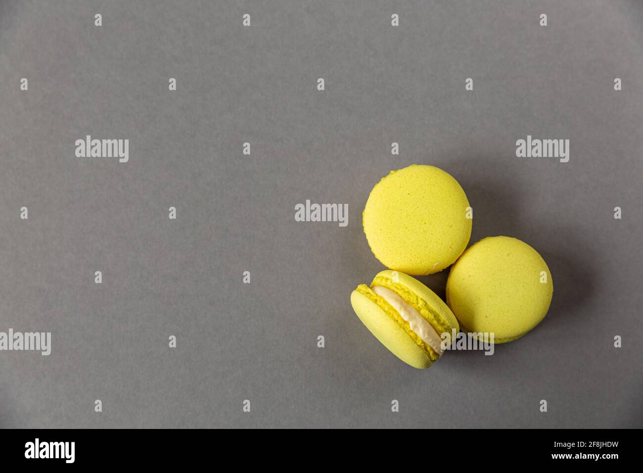 Yellow macarons on a gray background Stock Photo - Alamy