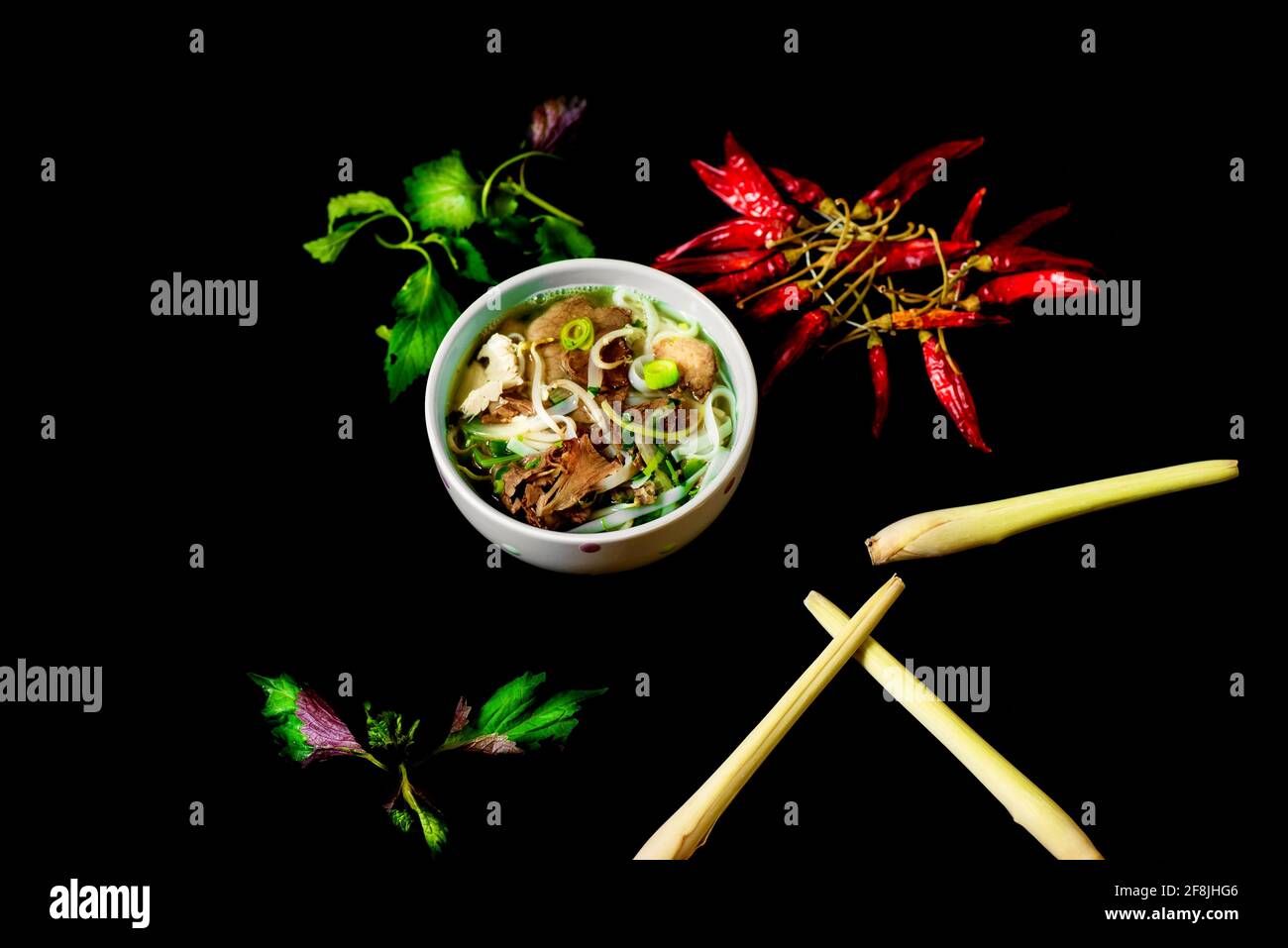 Gastronomy black background with bowl of vietnamese soup "pho", dried ...