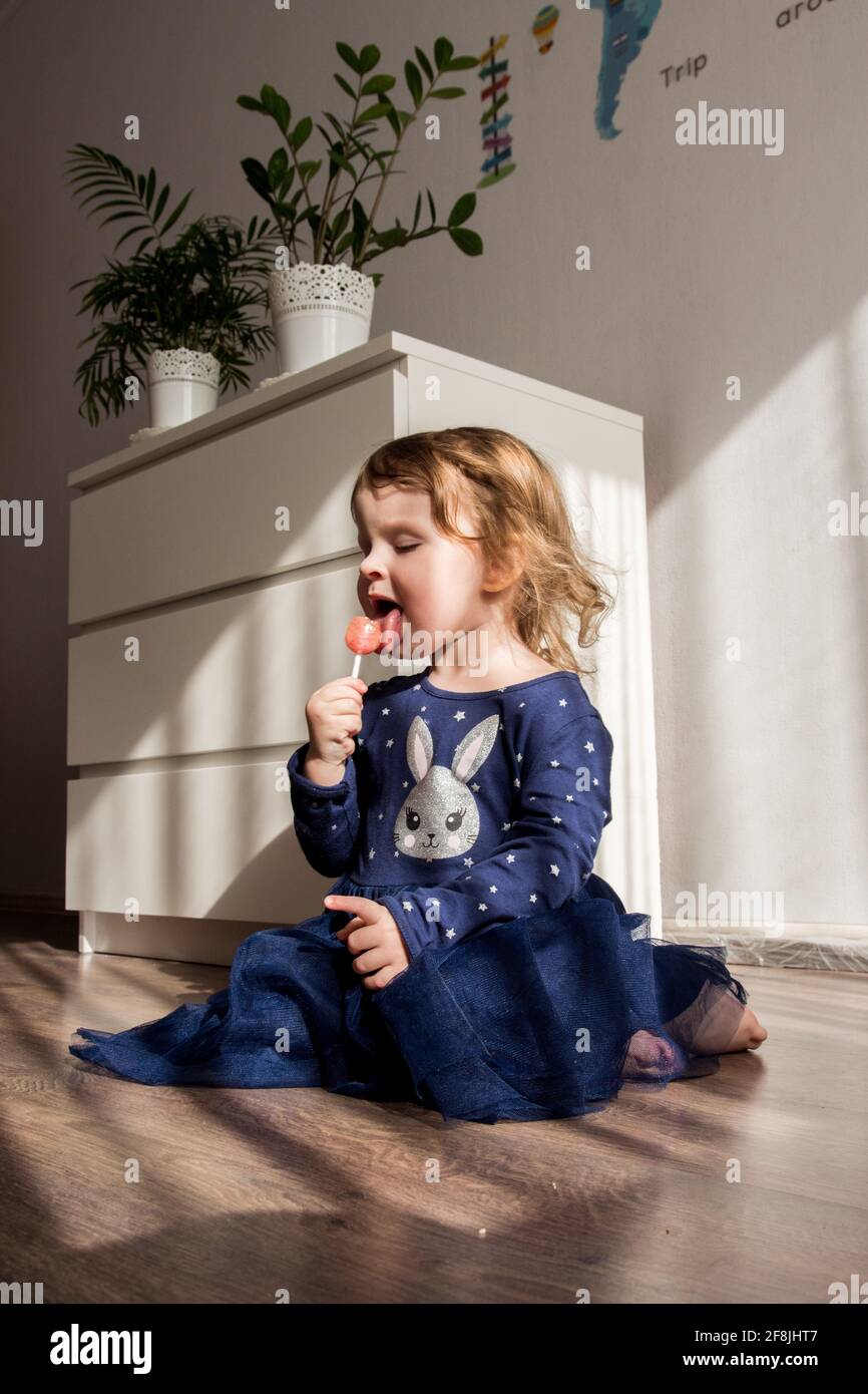 Boy girl eating lollipop hi-res stock photography and images - Alamy