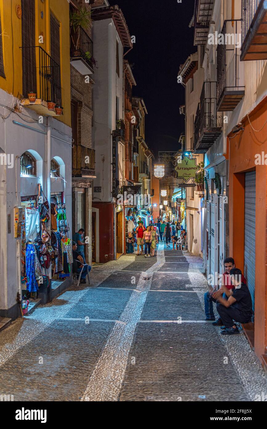 GRANADA, SPAIN, JUNE 21, 2019: Nightlife in a narrow street in Albaicin ...