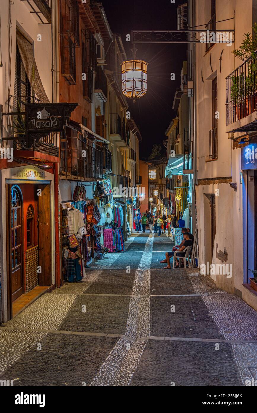 GRANADA, SPAIN, JUNE 21, 2019: Nightlife in a narrow street in Albaicin ...