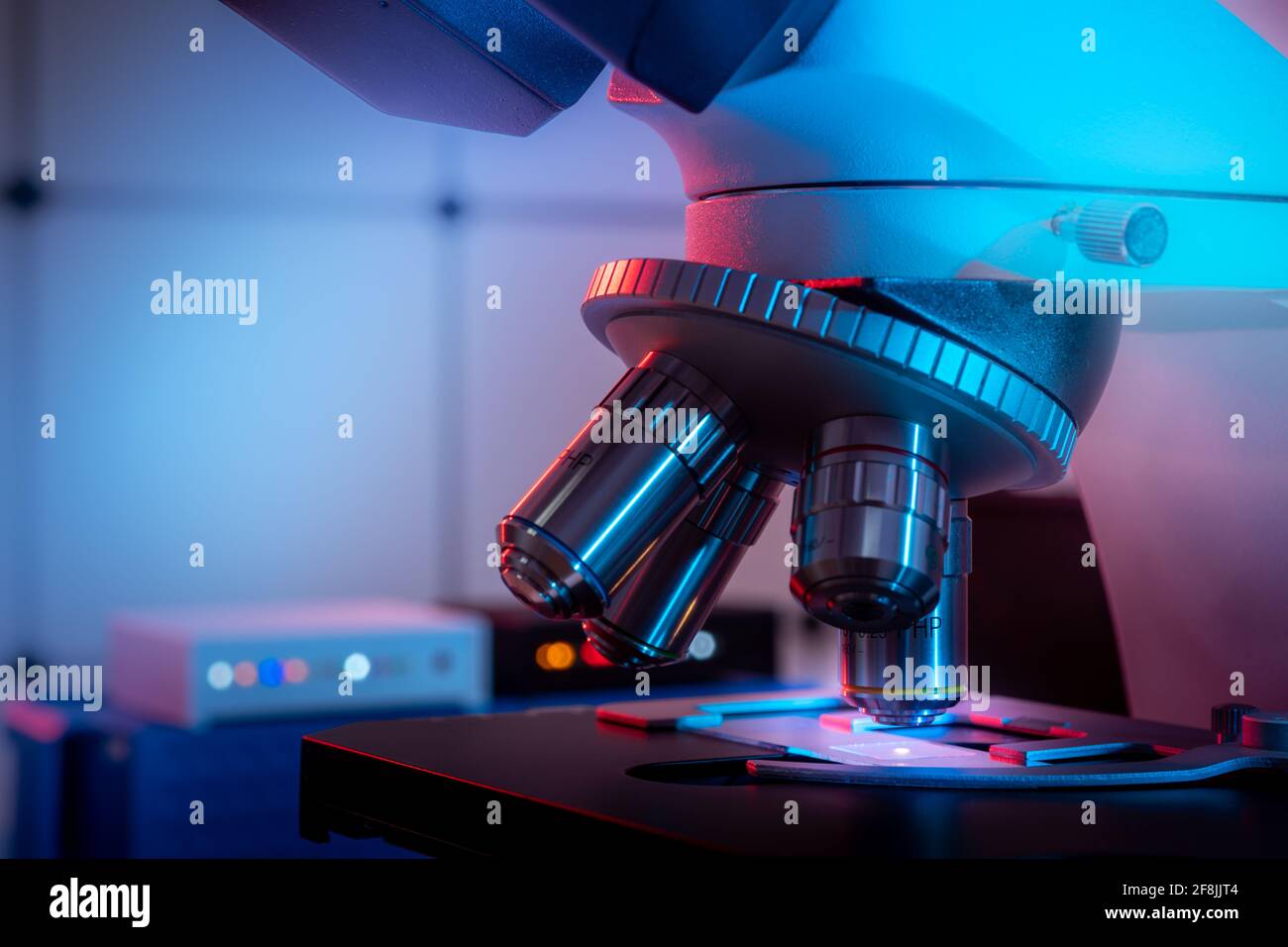 Toned photo of a backlit microscope lens in a science laboratory Stock ...