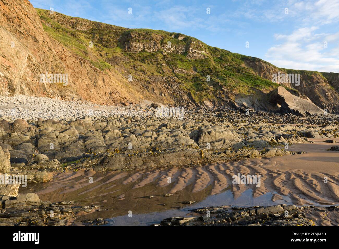 The cliff and exposed beach during low tide at Hartland Quay in the ...