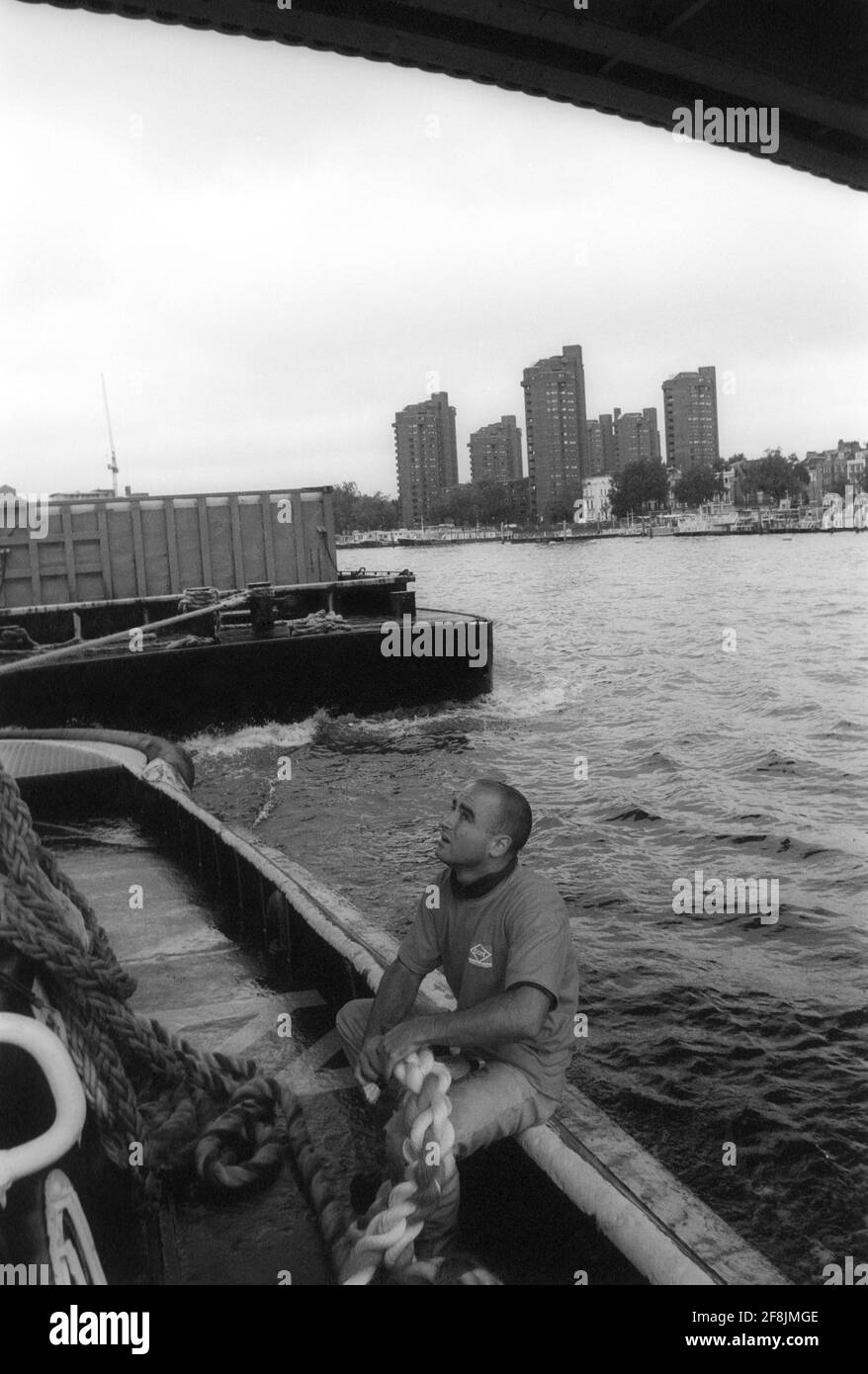 Lightermen of the River Thames using ropes to secure the barges for ...