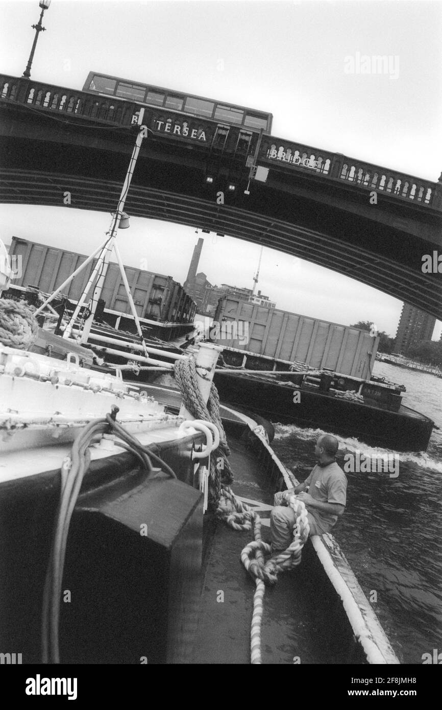 Lightermen of the River Thames using ropes to secure the barges for ...