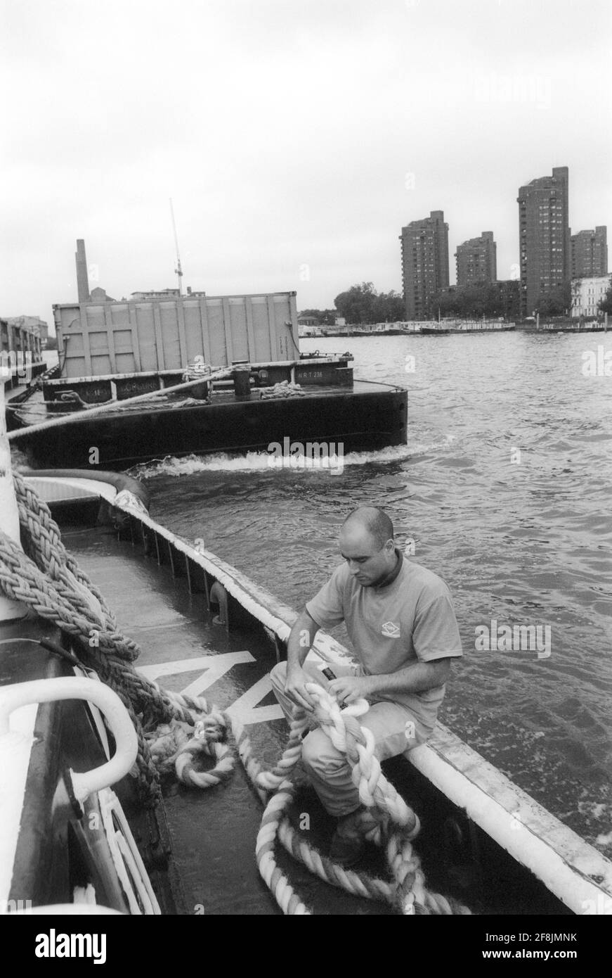 Lightermen of the River Thames using ropes to secure the barges for ...