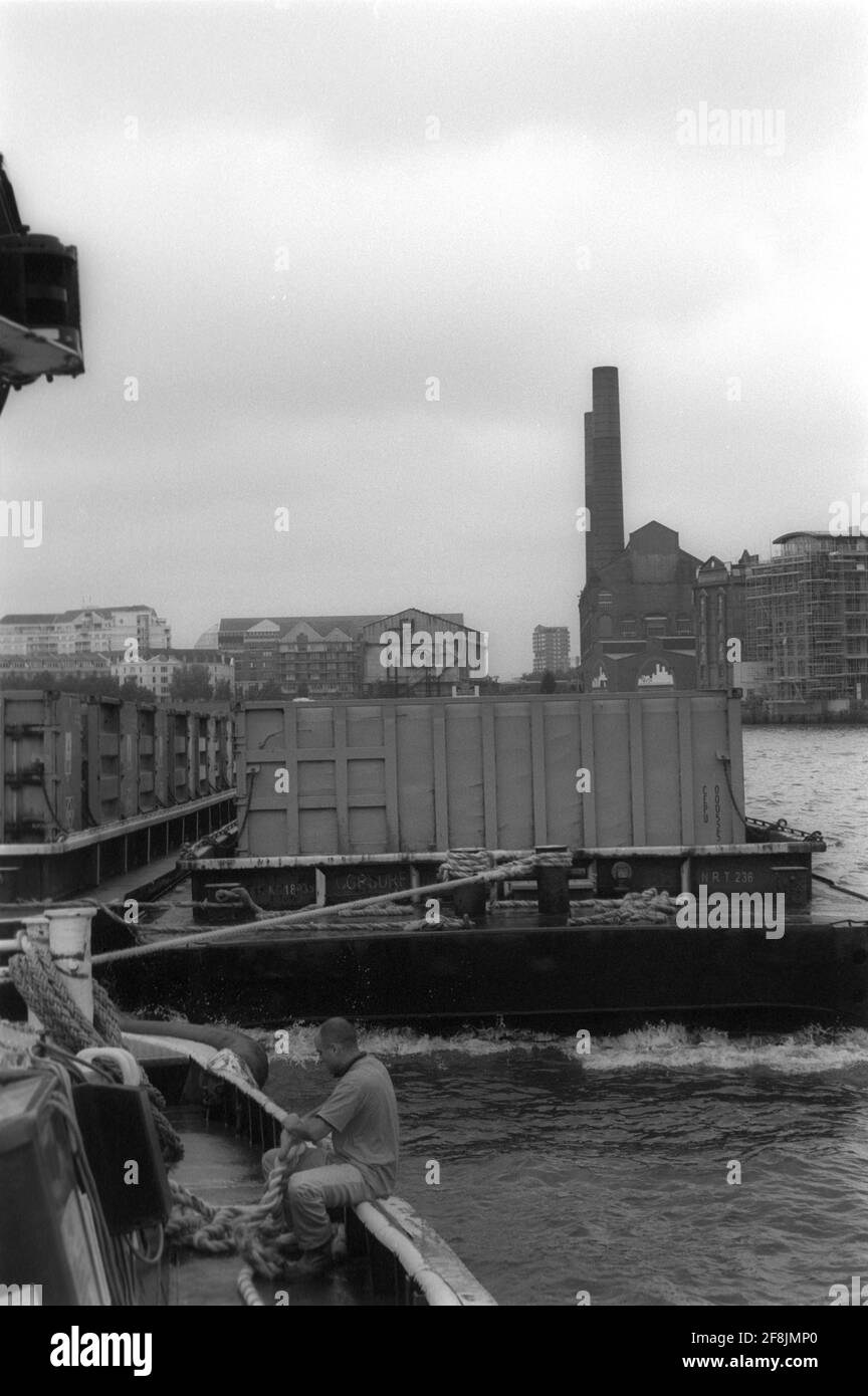 Lightermen of the River Thames using ropes to secure the barges for ...