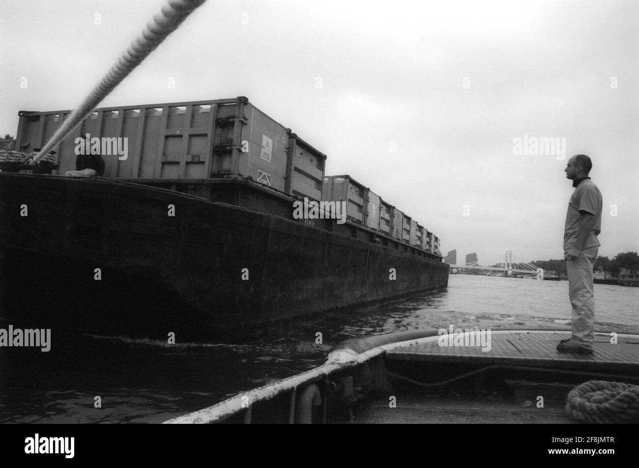Lightermen of the River Thames using ropes to secure the barges for ...