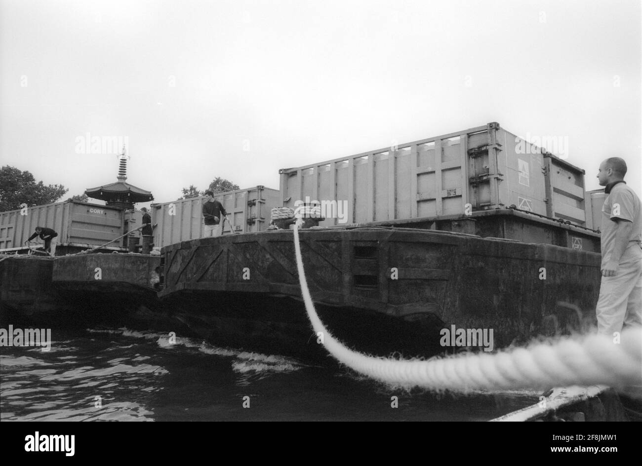 Lightermen of the River Thames using ropes to secure the barges for ...