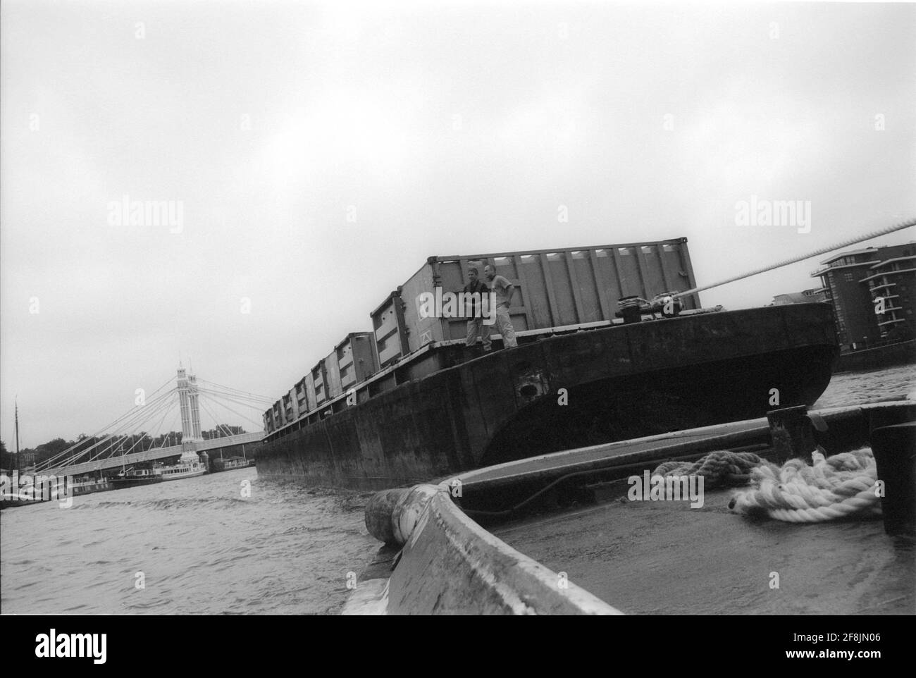 Lightermen of the River Thames using ropes to secure the barges for ...
