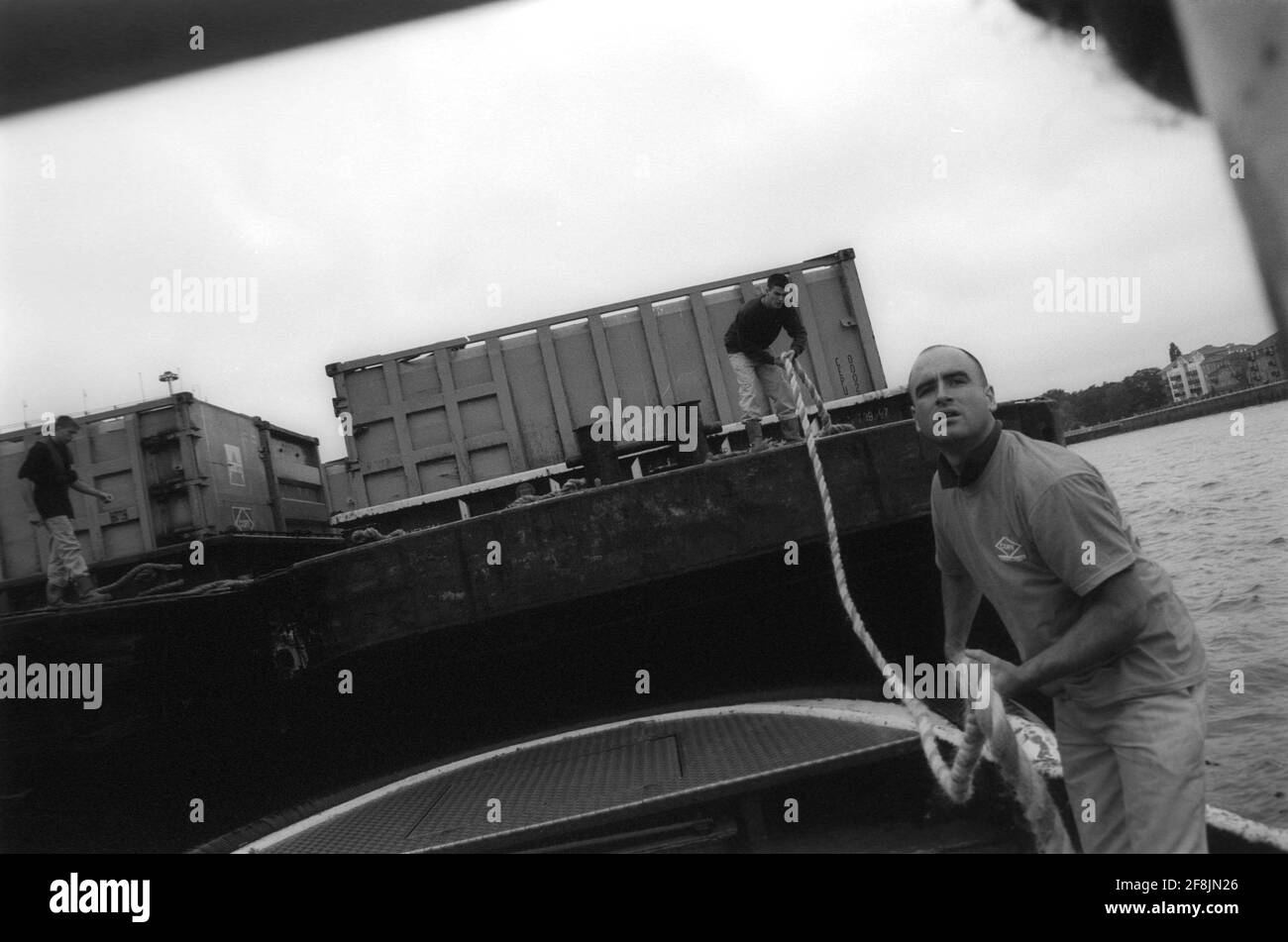 Lightermen of the River Thames using ropes to secure the barges for ...