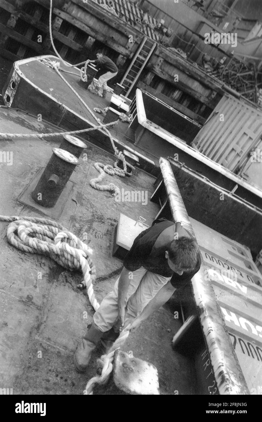 Lightermen of the River Thames using ropes to secure the barges for ...