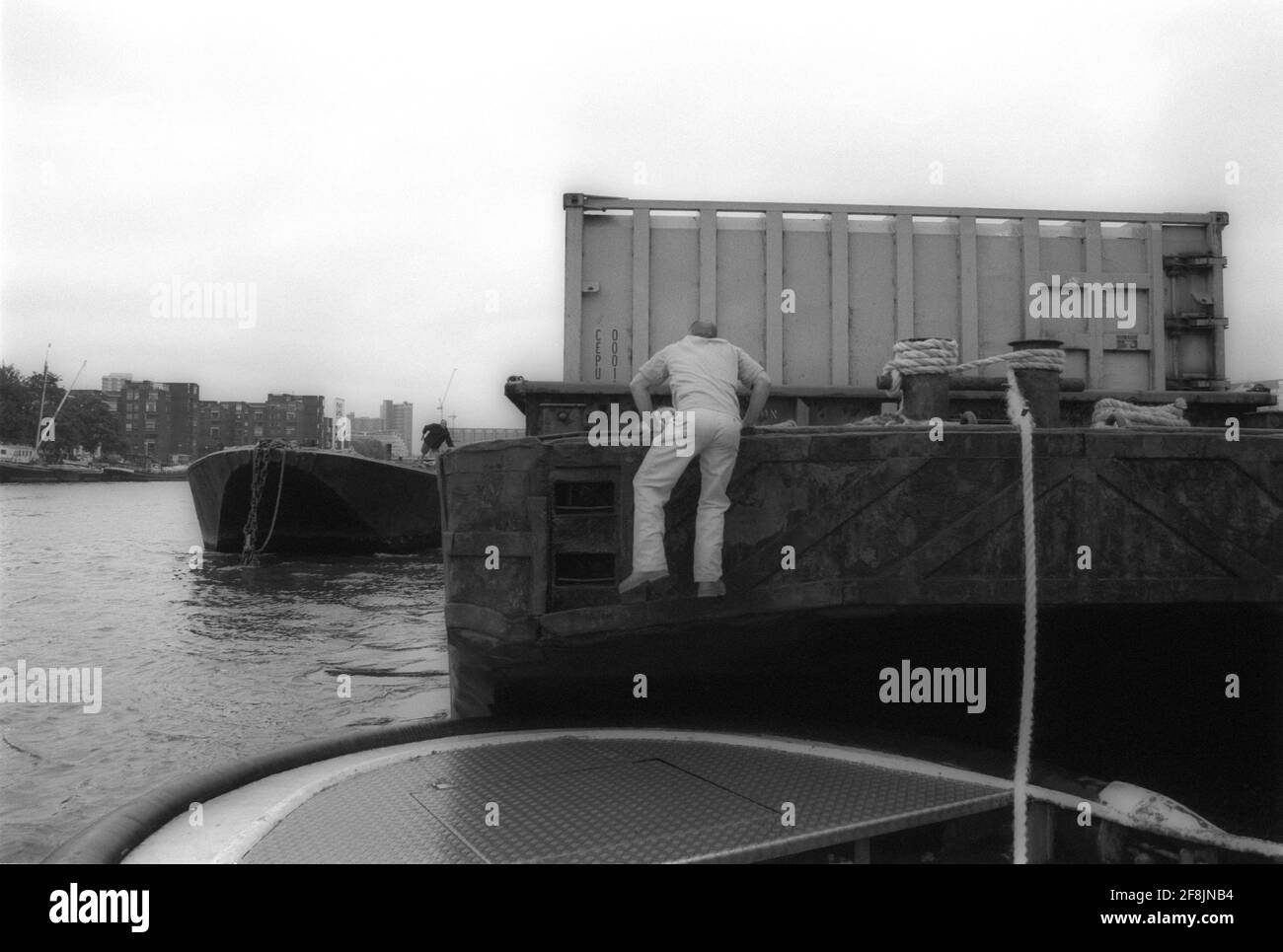 Lightermen of the River Thames working on the barges. working jumping ...