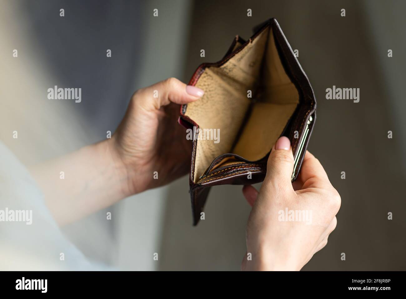 Woman holding an empty wallet Stock Photo - Alamy