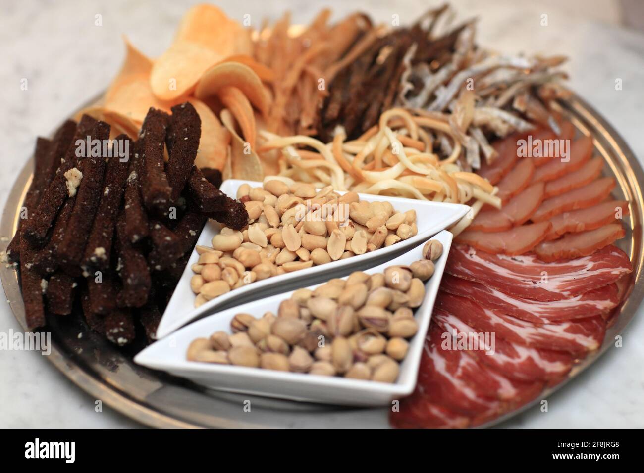 Plate of beer snack on a table at the pub Stock Photo - Alamy