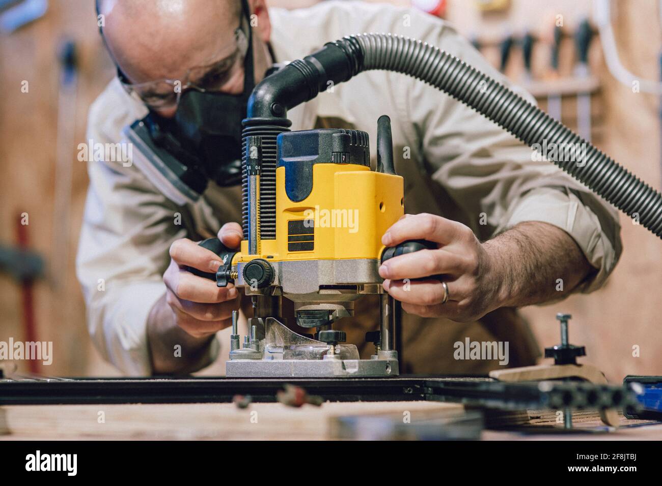 detail of a carpenter using a router machine inside his workshop Stock ...