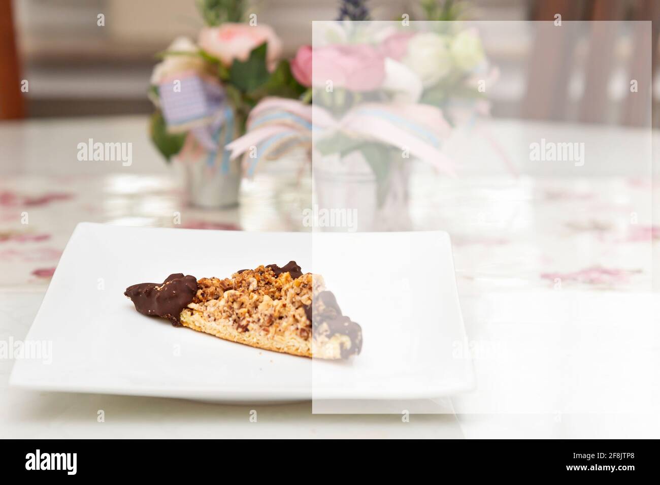 A homemade nut corner (pastry) on a plate on decorated table. On the ...