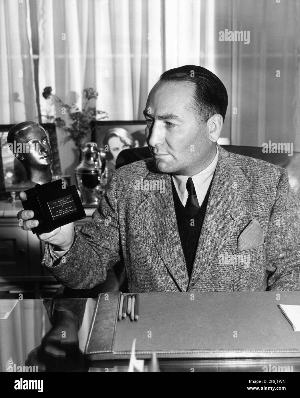 Legendary Producer HAL B. WALLIS poses in his office at Warner Bros ...