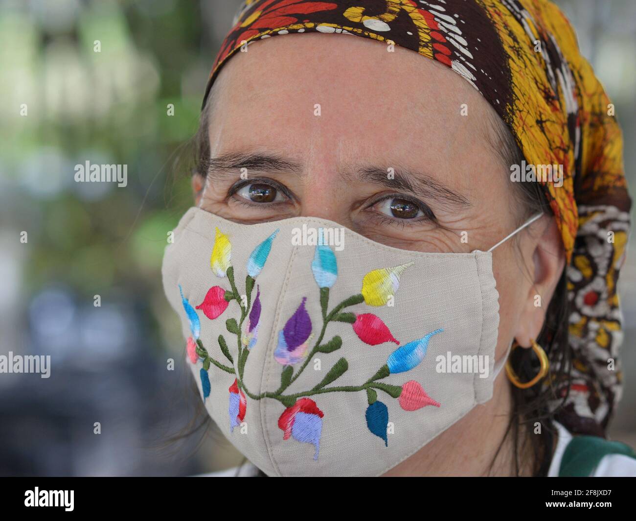 Elderly Caucasian farm woman with beautiful eyes wears an embroidered ...