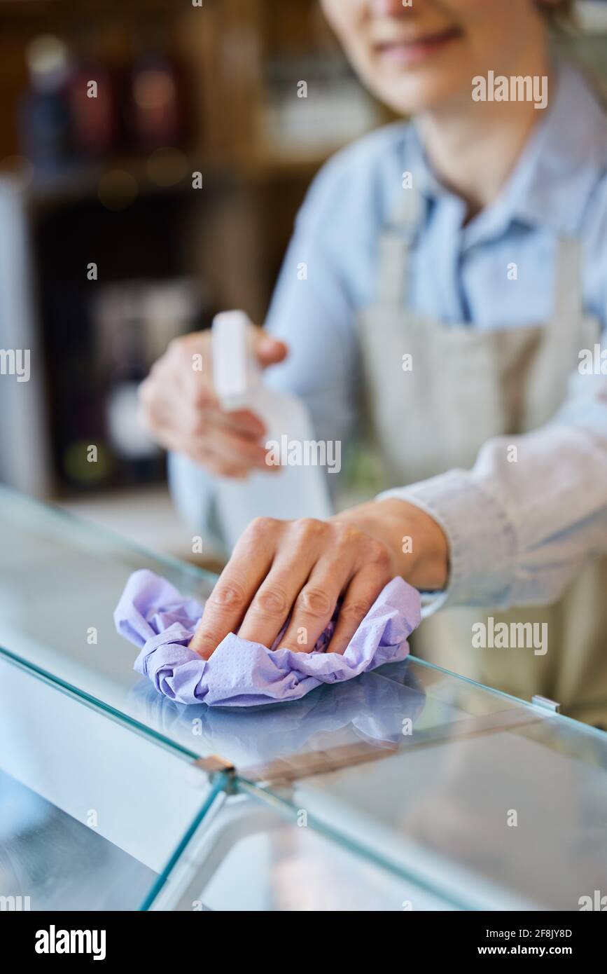 Female Owner Delicatessen Cleaning Counter With Sanitising Spray Stock ...