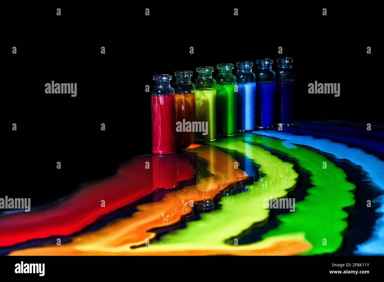 Modern still life depicting seven colors of rainbow on a black ...