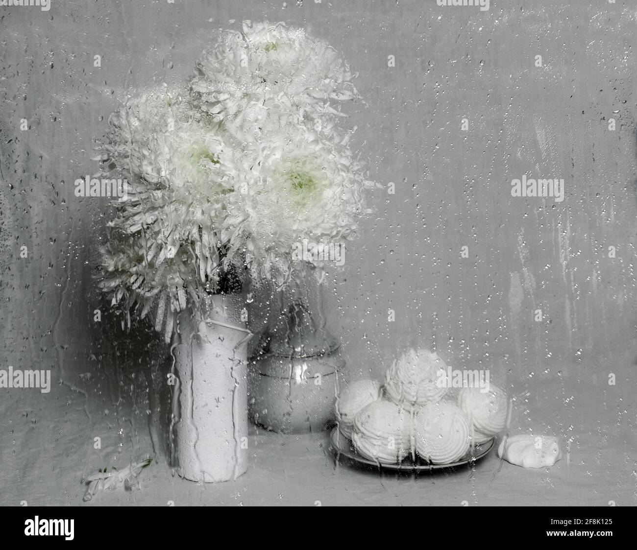 White still life. White flowers in a white vase with white marshmallows ...