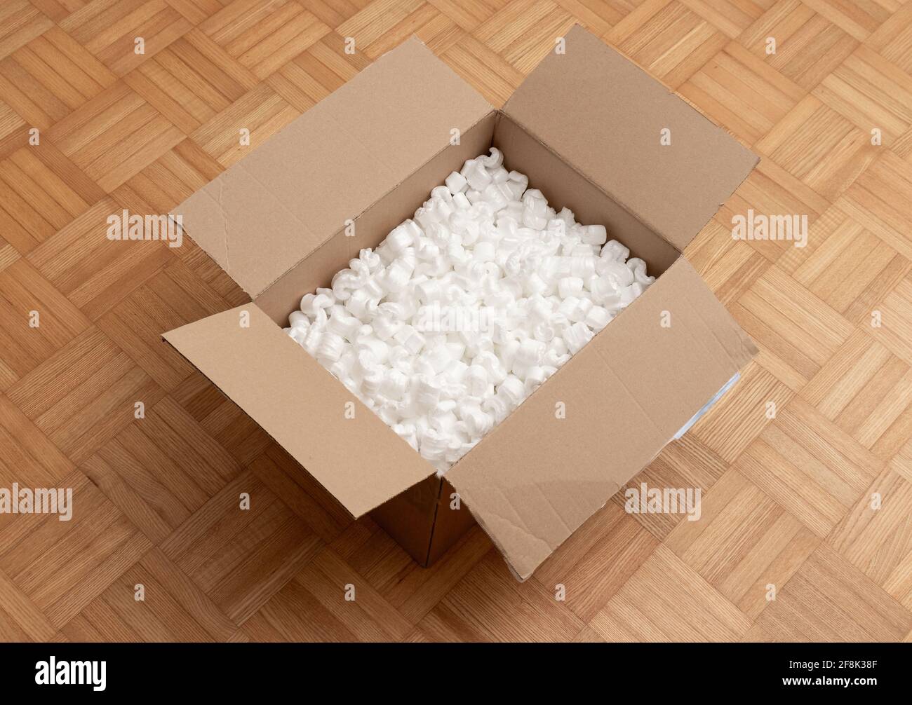 A cardboard box with packing styro foam pellets top view Stock Photo ...